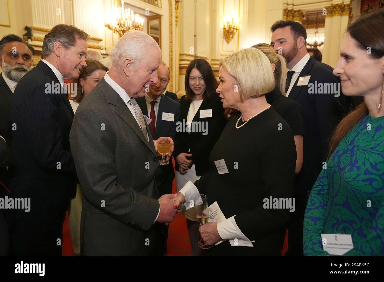 King Charles III talking to Rachel Gilmour during a reception for ...