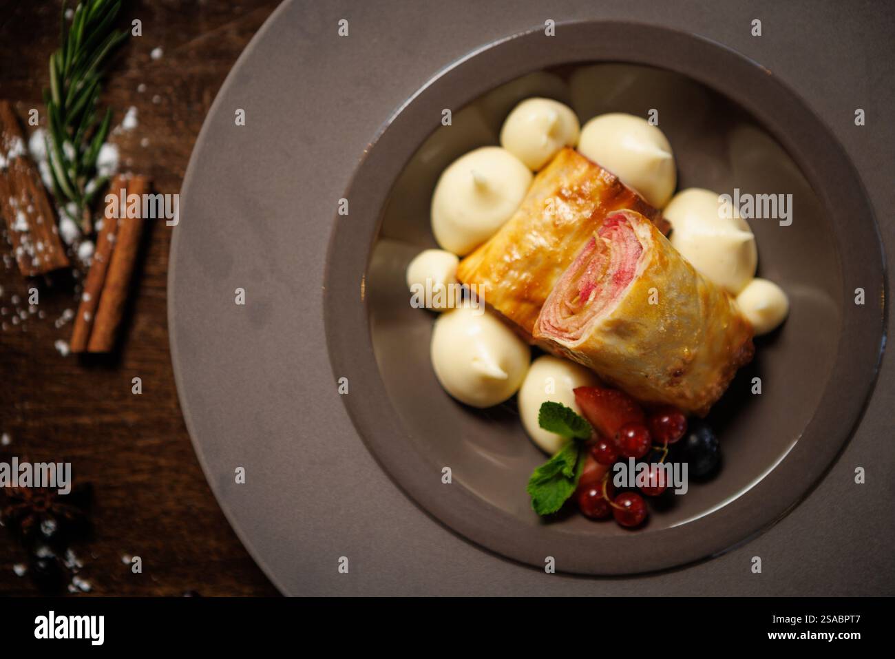 Puff pastry dessert with berry filling. Served with vanilla cream ...