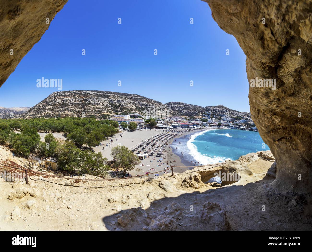 View from the rock caves to the beach of Matala, south coast, Crete ...