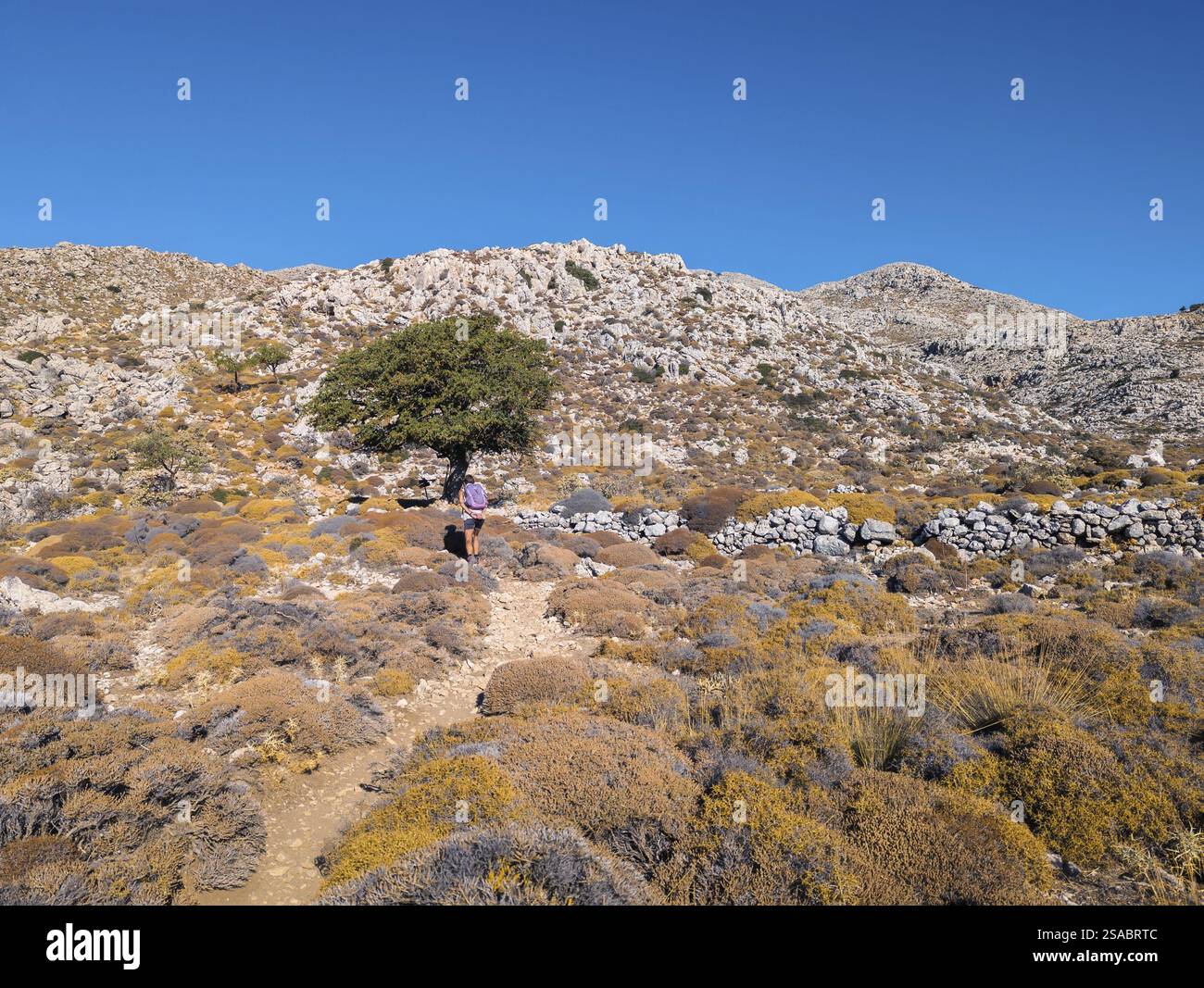 The hiking trail to Kali Limni leads through barren landscape with ...