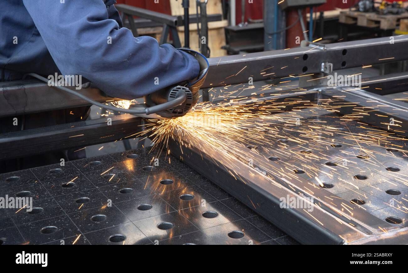 Sharpen metal. At the metal factory Stock Photo - Alamy