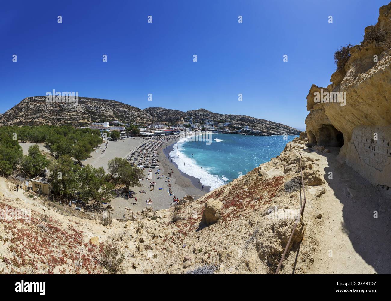 View from the rock caves to the beach of Matala, south coast, Crete ...