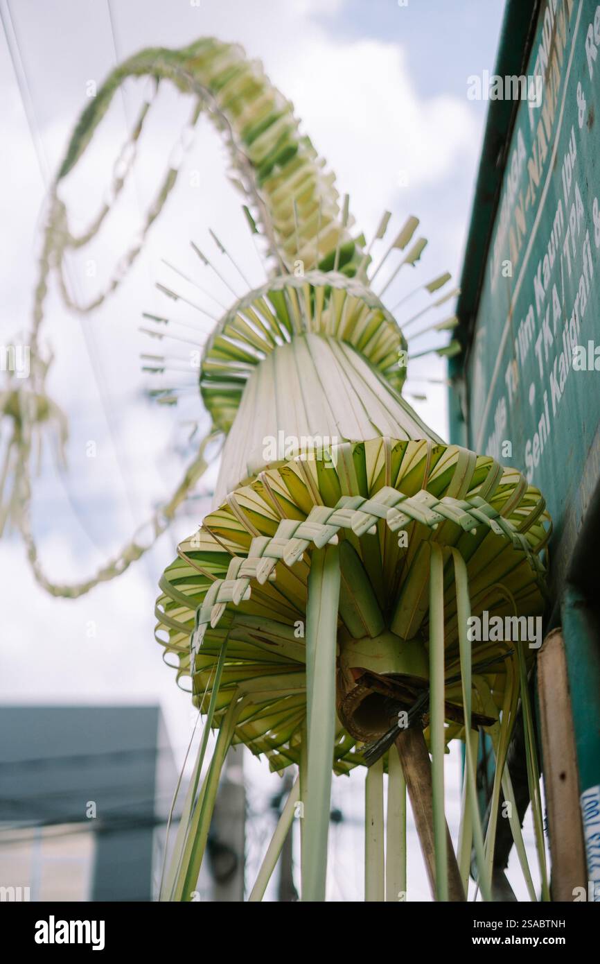 Traditional Balinese Penjor decoration made of woven coconut leaves ...