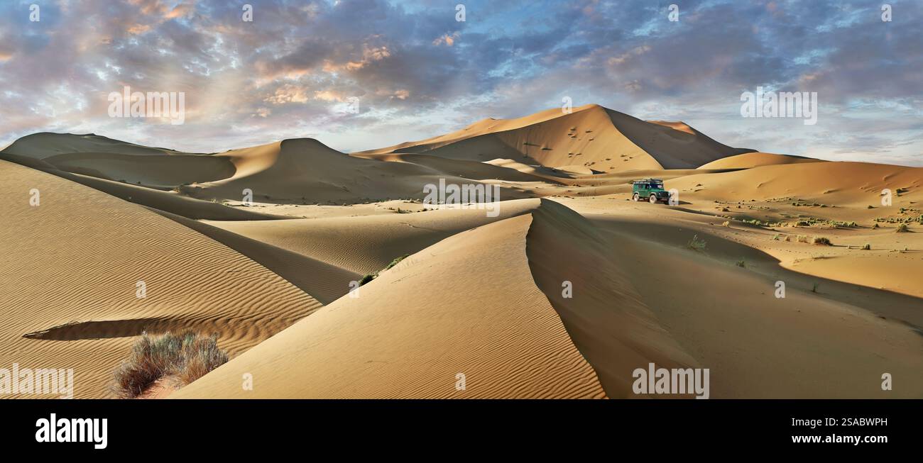 land Rover Defender 4x4 driving in the Erg Chebbi Sahara sand sune belt ...