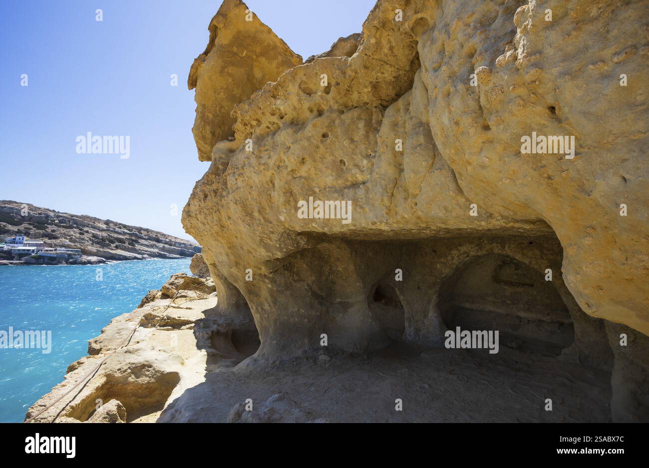View from the rock caves to the beach of Matala, south coast, Crete ...