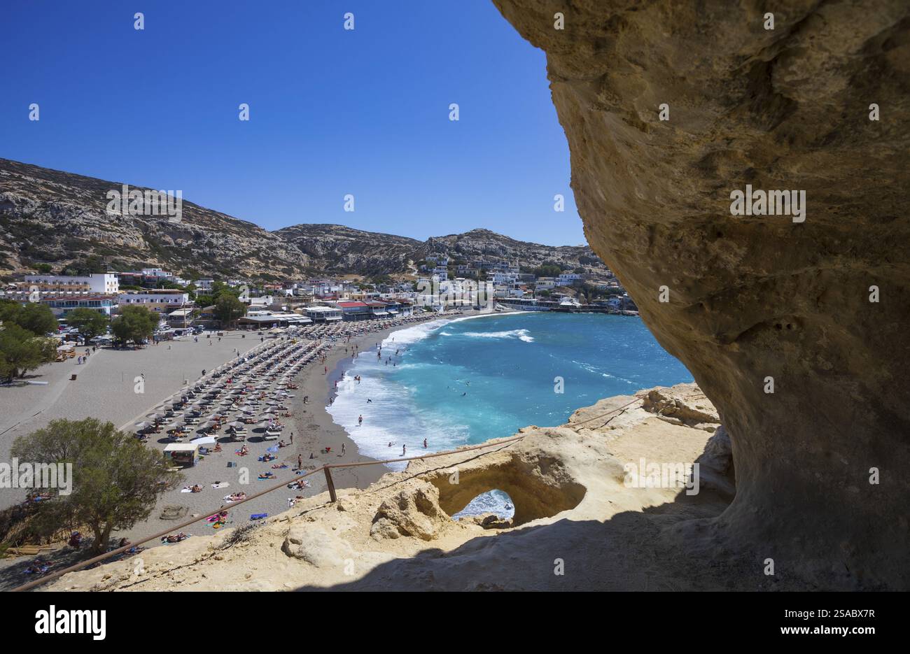 View from the rock caves to the beach of Matala, south coast, Crete ...