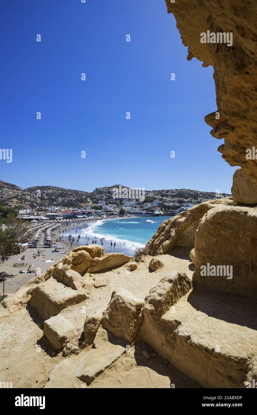 View from the rock caves to the beach of Matala, south coast, Crete ...