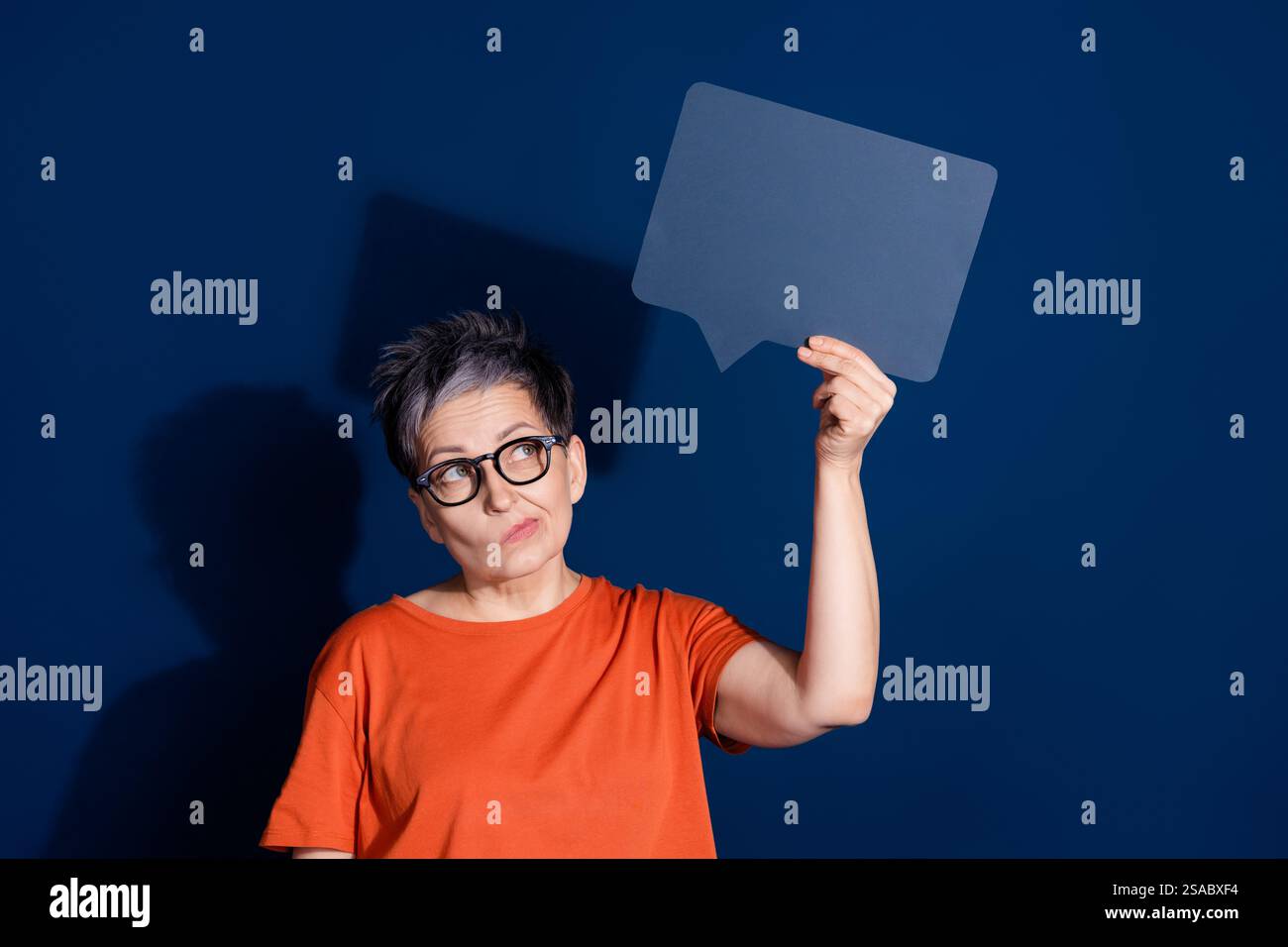 Photo portrait of pretty retired female look skeptical paper comment ...