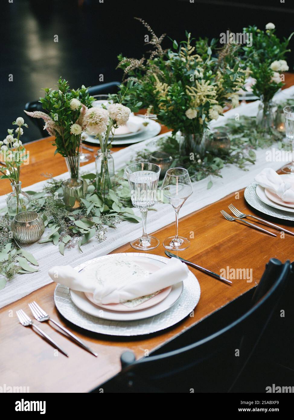 A beautifully arranged dinner table showcases delicate floral ...