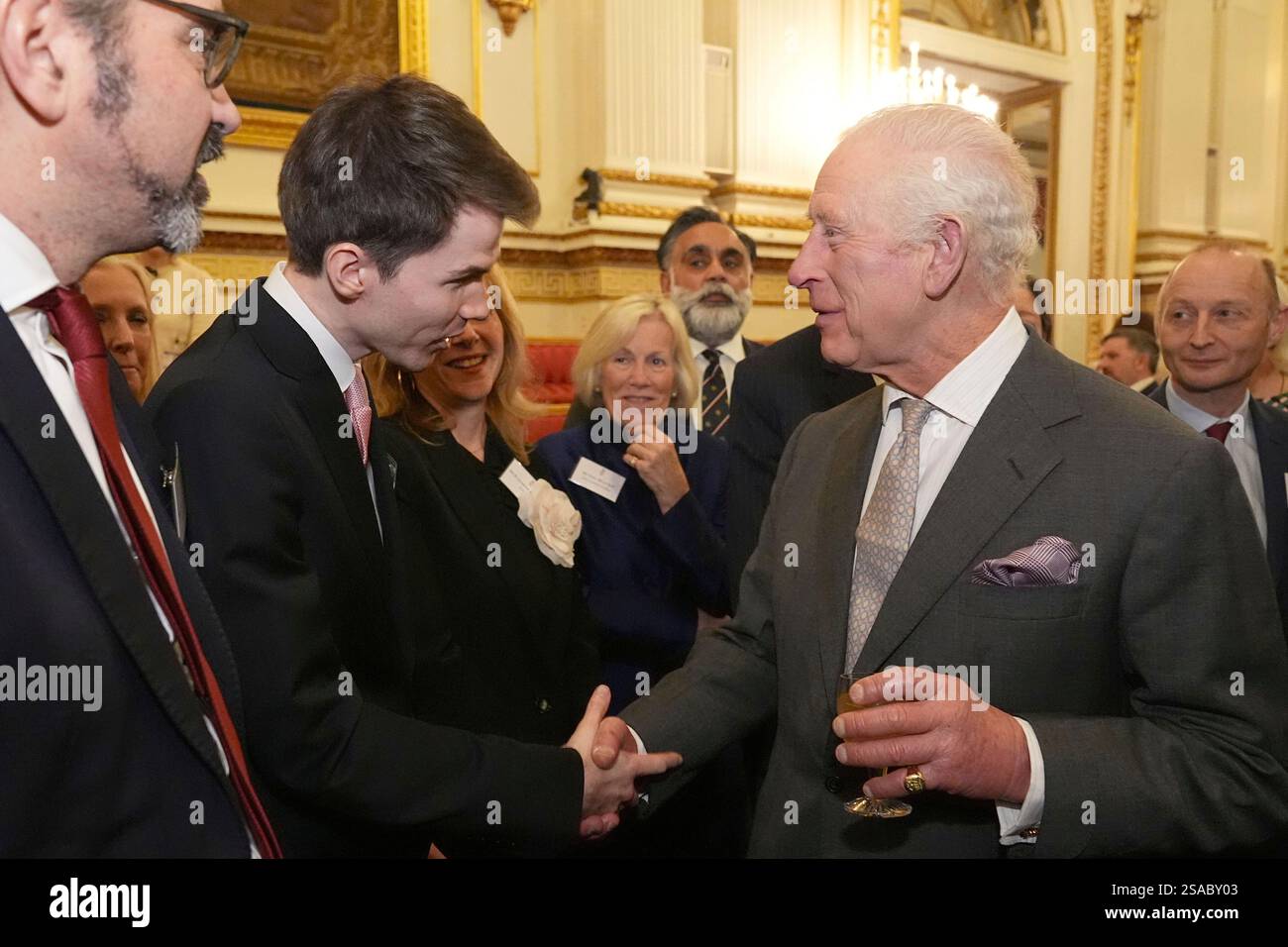Britain's King Charles III speaks to Gordon McKee during a reception ...