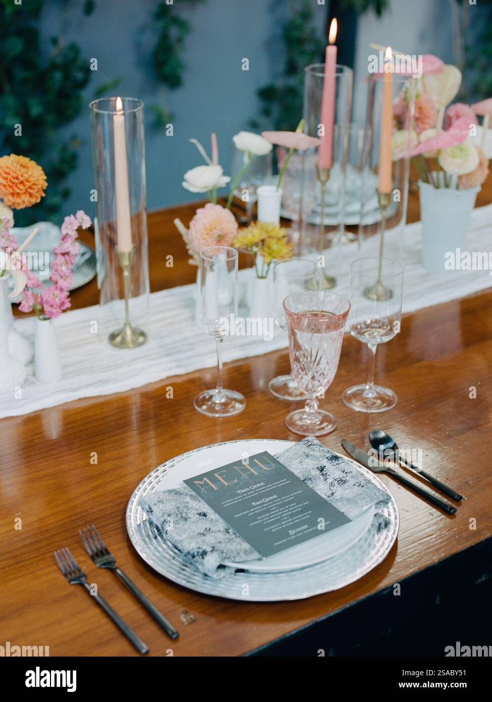 A beautifully arranged dining table showcases floral centerpieces ...