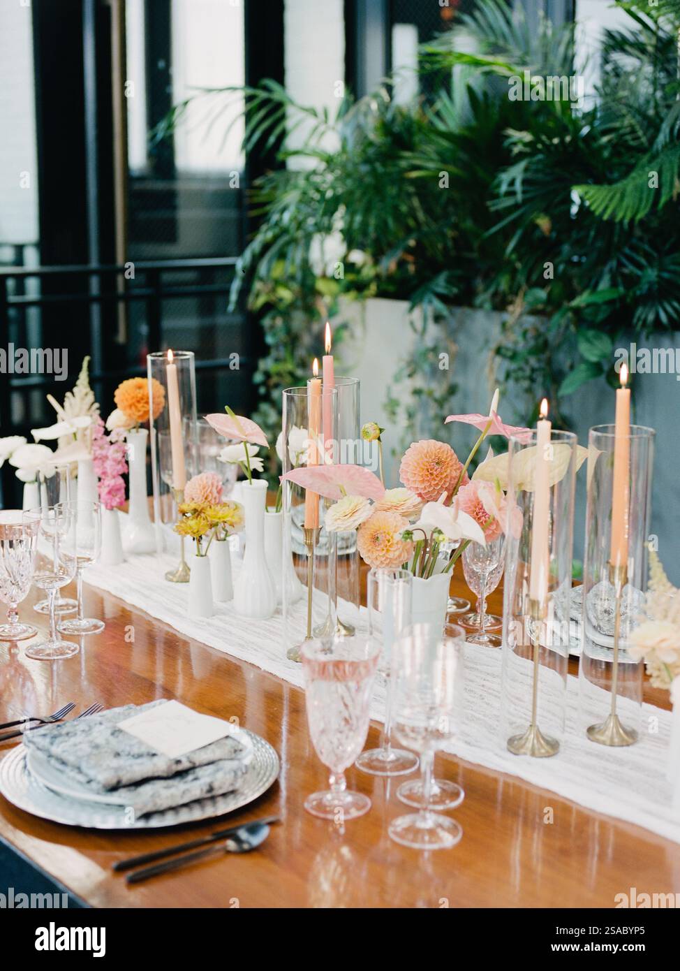 A beautifully arranged dining table showcases floral centerpieces and ...