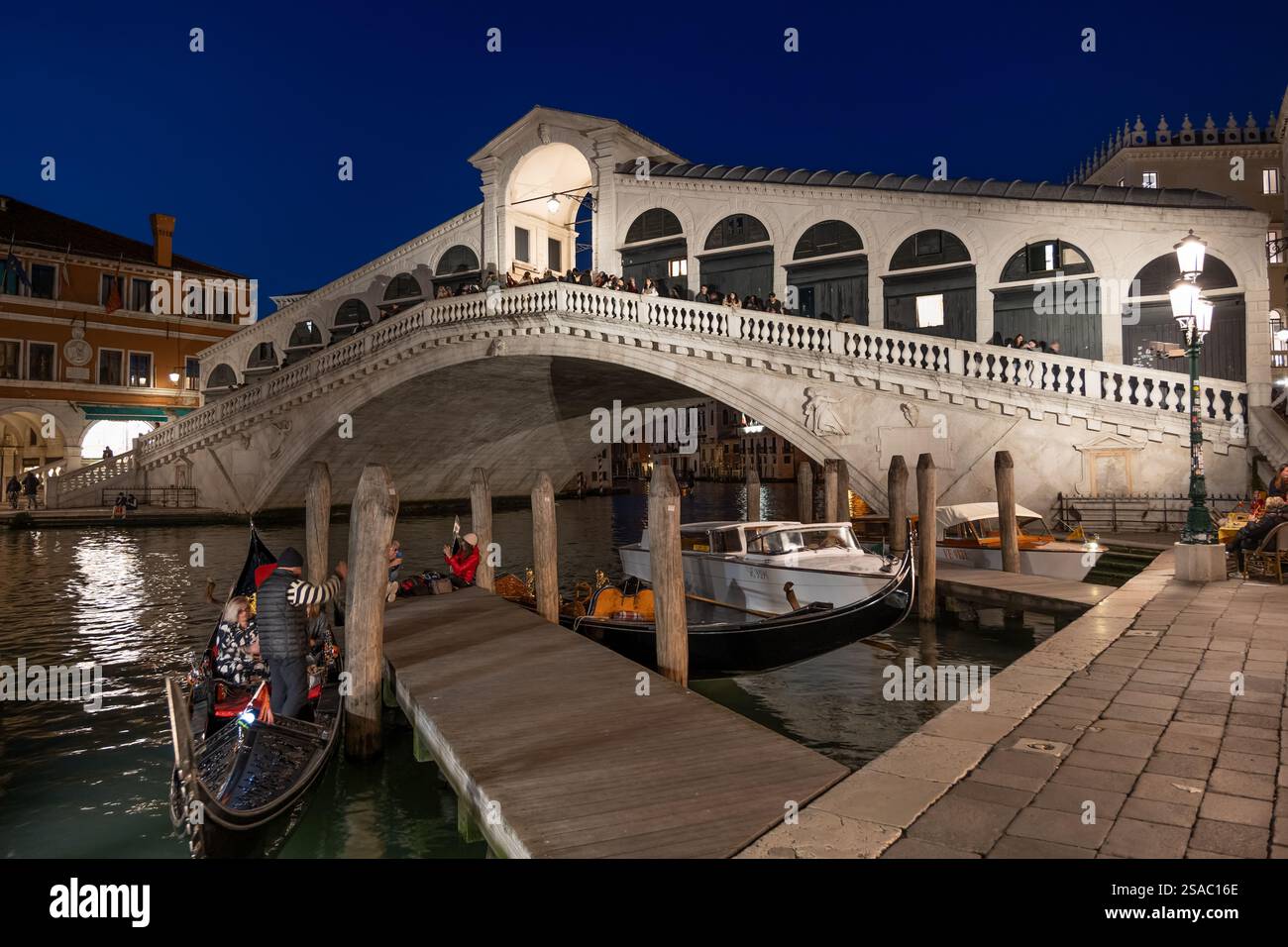 The Rialto Bridge at night in city of Venice, Italy. Stone arch ...