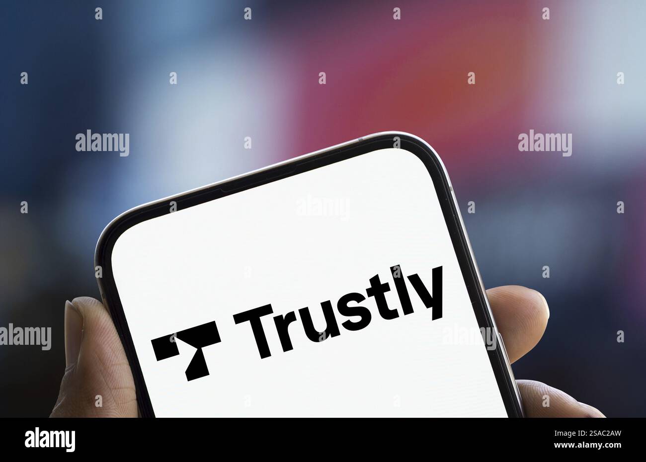 Trustly logo is displayed on smartphone. Trustly AB is a Swedish ...