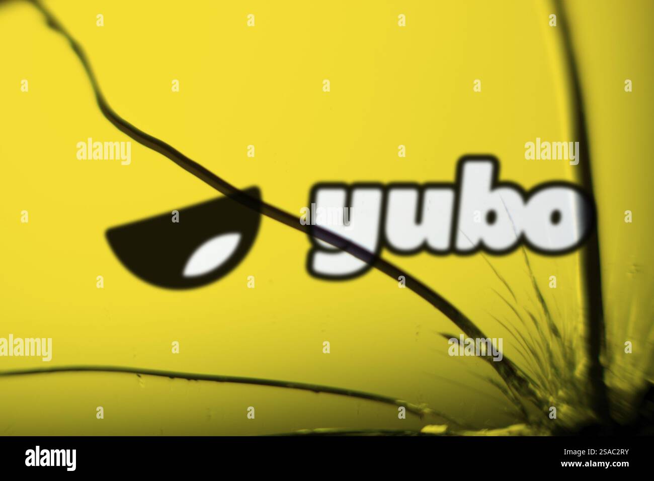 yubo logo is visible on the broken glass.Yubo is a French social networking app Stock Photo - Alamy