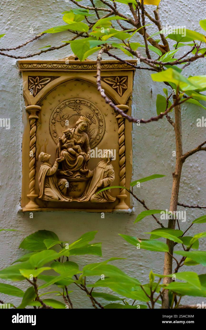 Religious Wall Sculpture in Greenery Featuring Iconic Blessed Figures ...