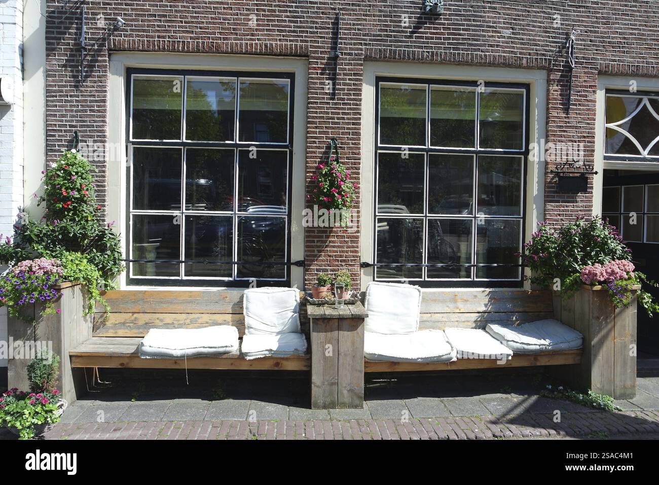 Bench under the windows Stock Photo - Alamy