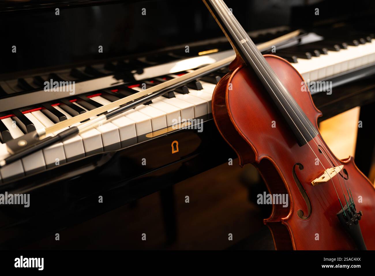 Violin on top of piano keyboard background with copy space for music ...