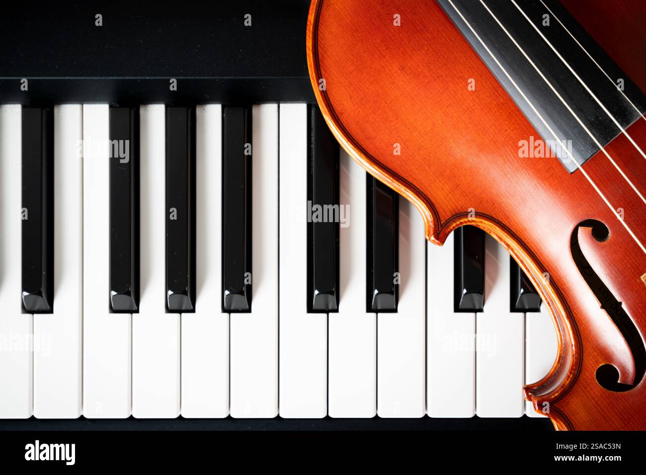 Violin on top of piano keyboard background with copy space for music ...
