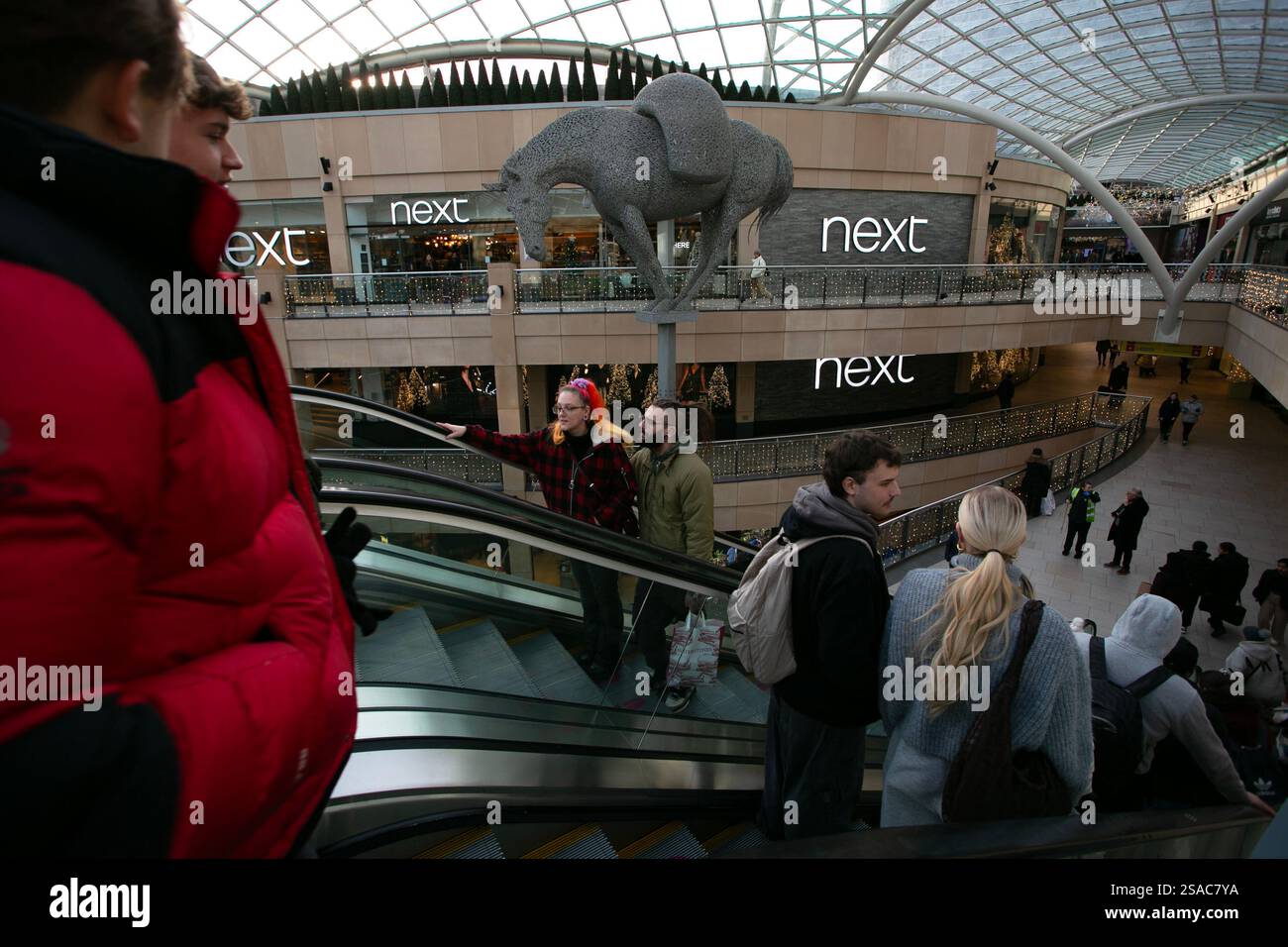Christmas shoppers on escalators in the Trinity shopping Mall in Leeds ...