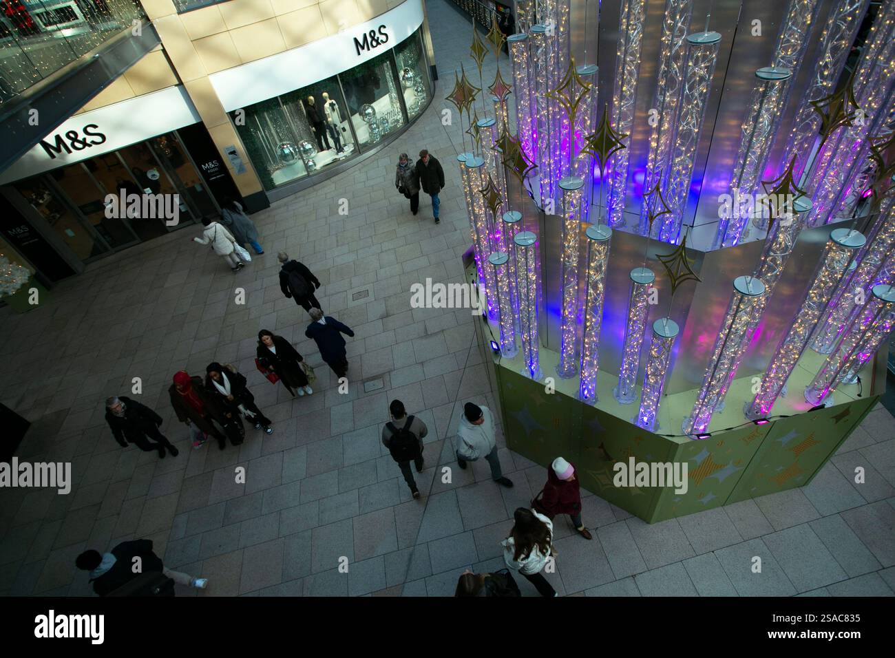 Christmas shoppers walk past festive decorations in the Trinity ...