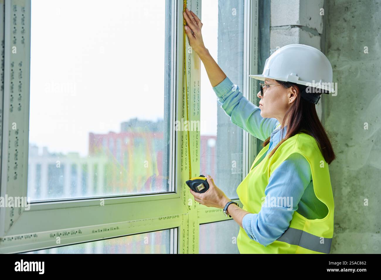 Industrial worker, woman measuring window with tape measure at ...