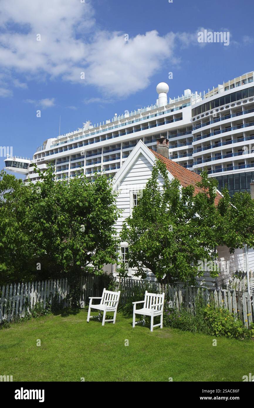 Cruise ship behind old town house Stock Photo - Alamy