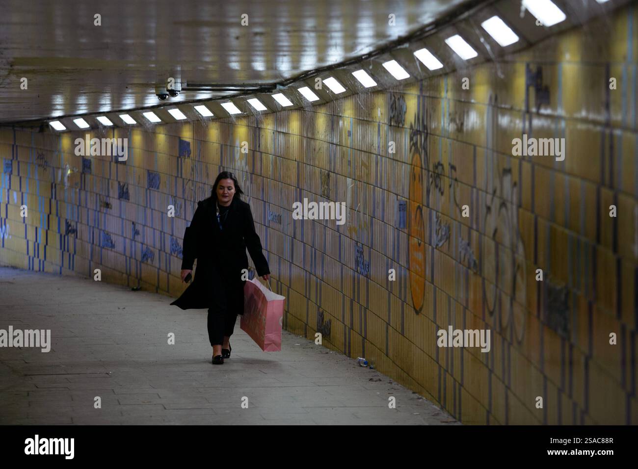 A woman walks along a run-down subway underpass in Leeds city centre ...