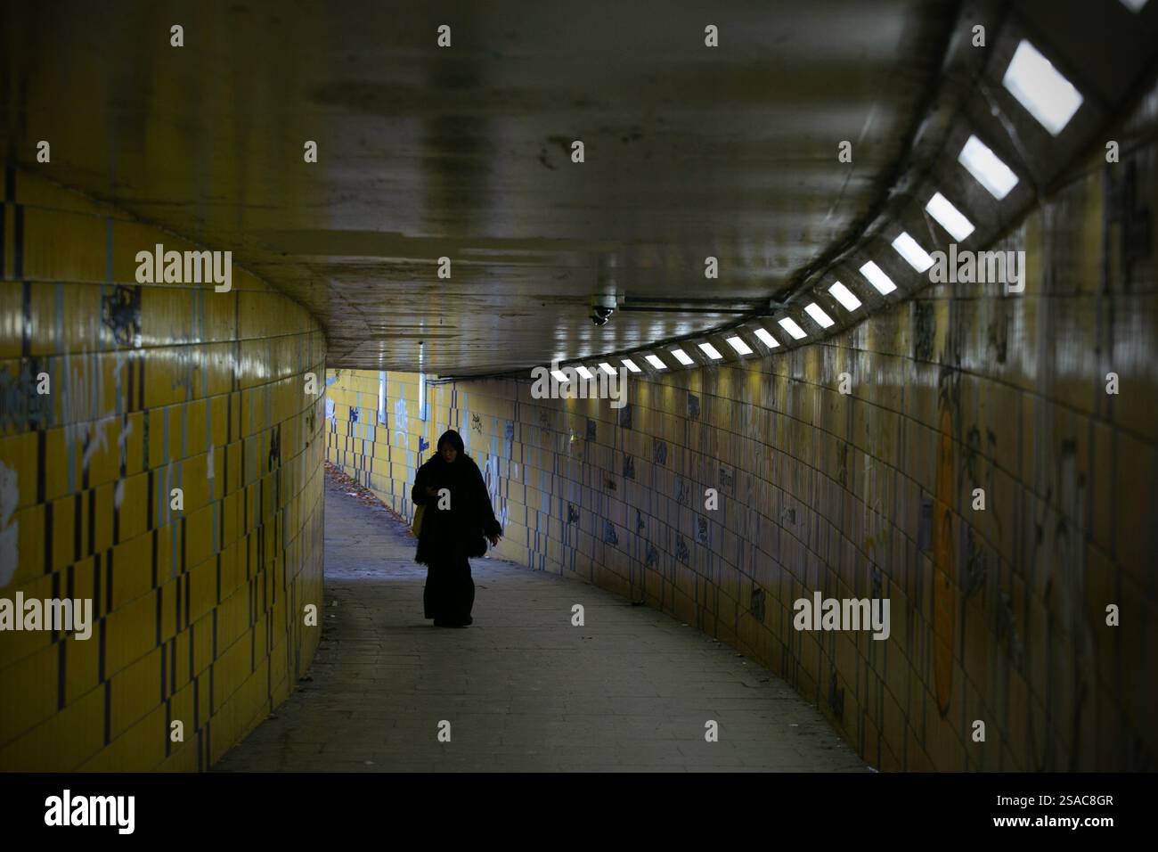 A woman walks along a run-down subway underpass in Leeds city centre ...