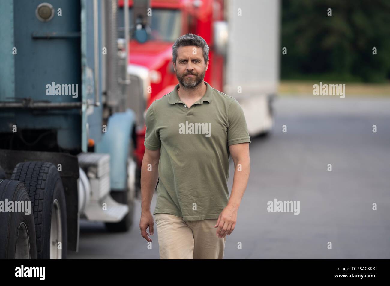 Handsome man driver in front of truck. Trucking owner. Truck driver ...