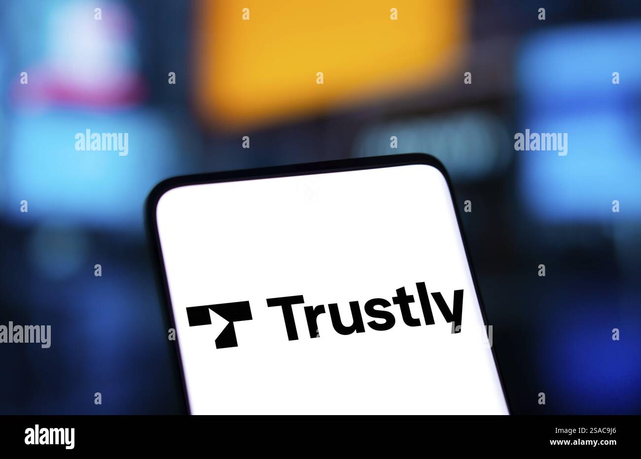 Trustly logo is displayed on smartphone. Trustly AB is a Swedish ...