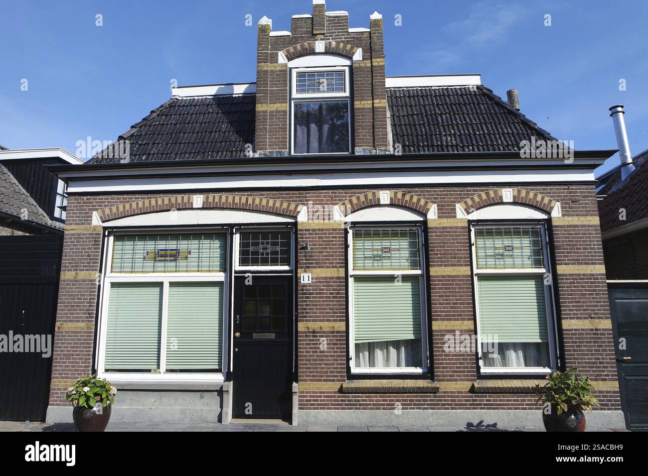 Brick house with tiled roof and dormer window Stock Photo - Alamy