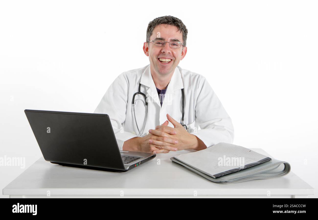 Medical Admin: A Friendly Face. A smiling doctor sitting at his desk ...