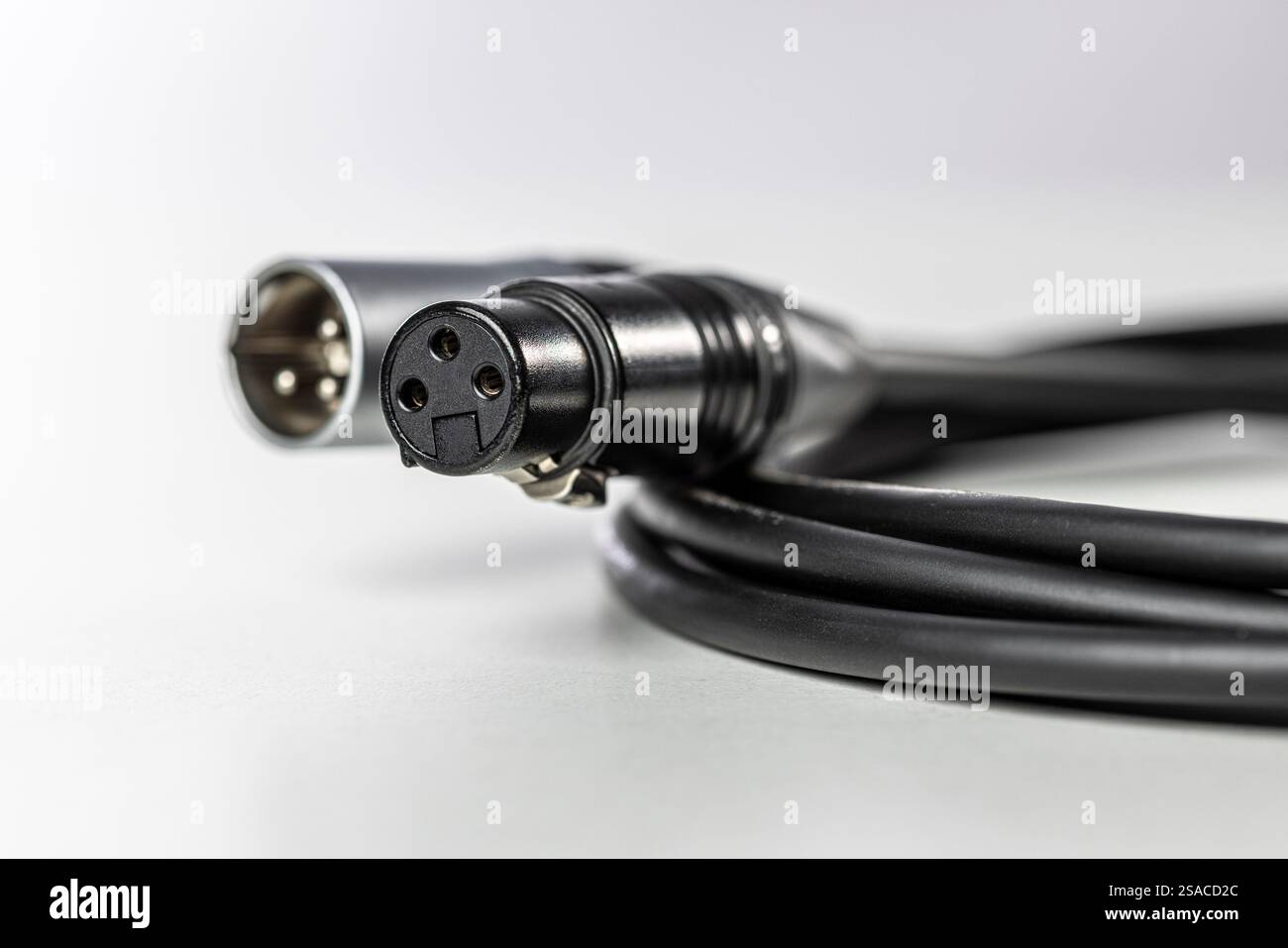 Xlr cable connecting audio devices on white background Stock Photo - Alamy