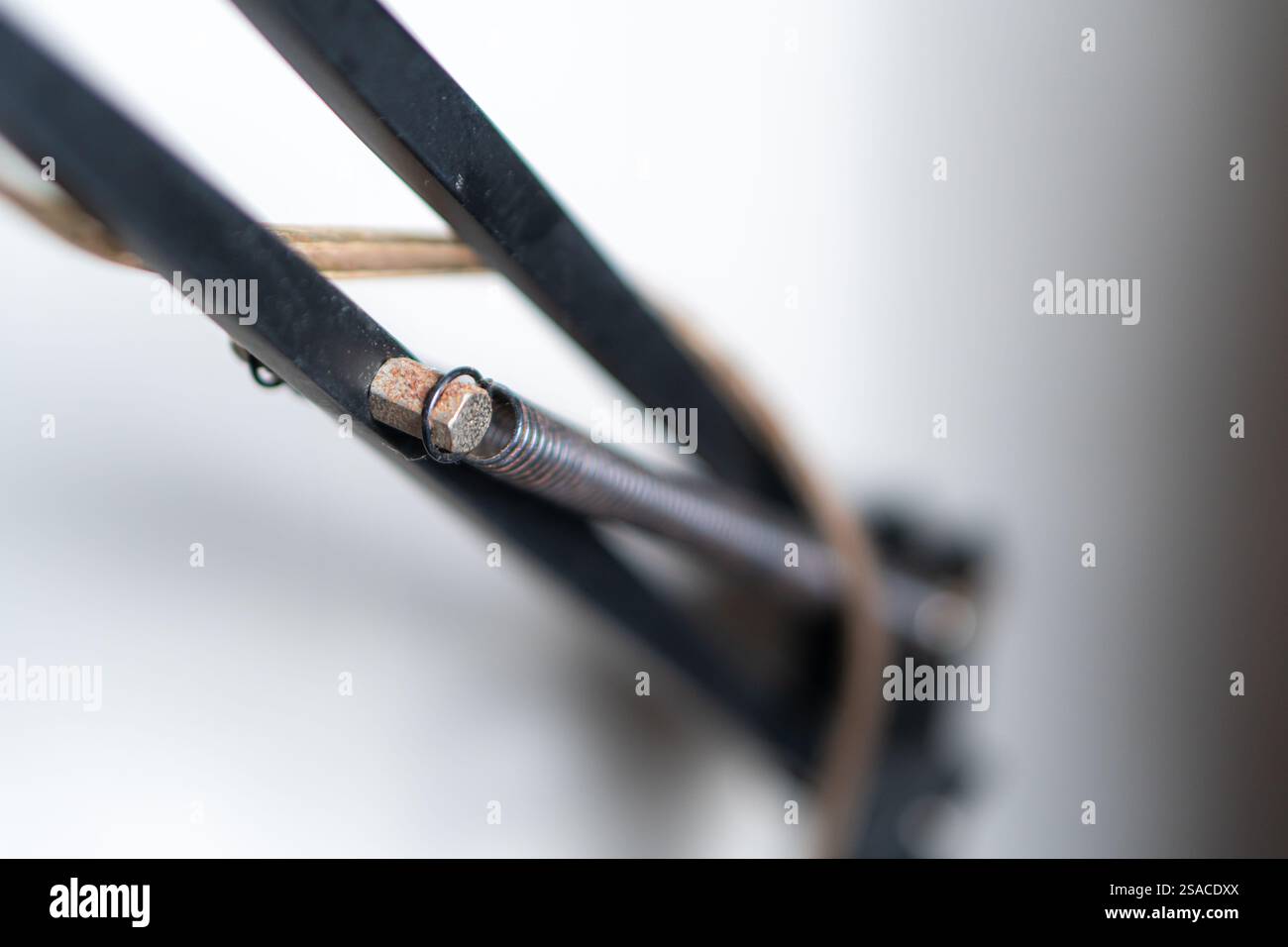 A close-up view of a mechanical arm with a textured cylindrical object ...