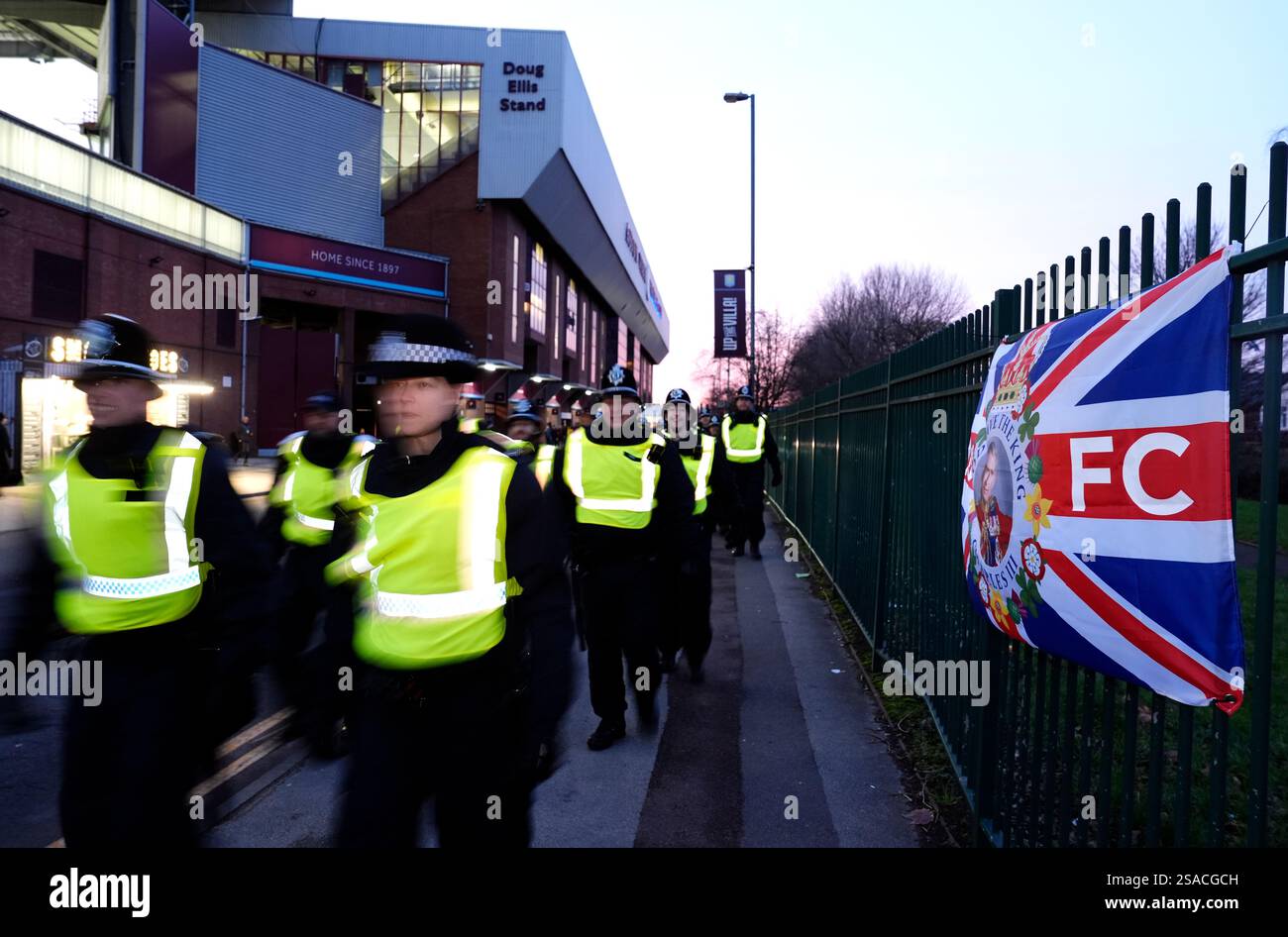 The police walk past a flag with the Union Jack and King Charles ...