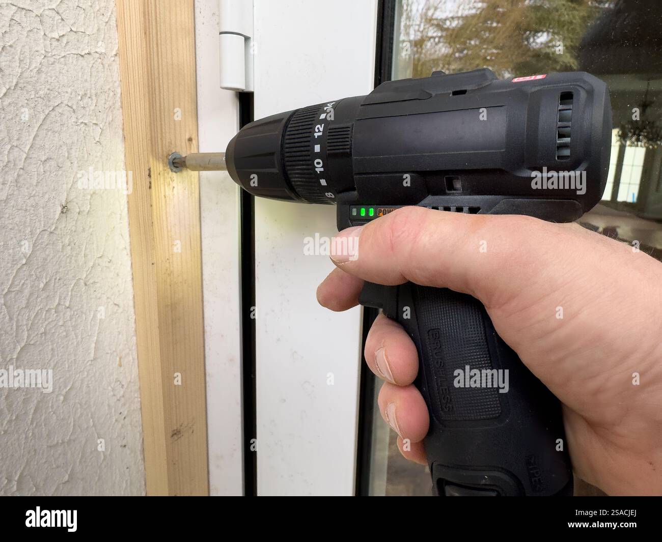 Screwdriver in action as wood is secured at a construction site Stock ...
