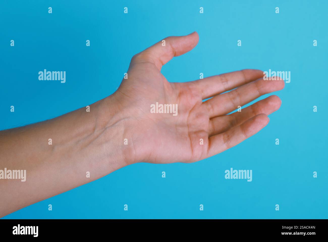 Woman with visible hand veins on light blue background, closeup Stock Photo - Alamy