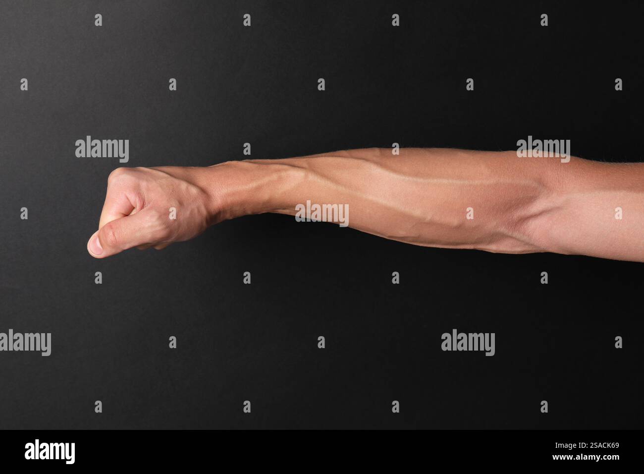 Man with bulging veins on his arm against black background, closeup ...
