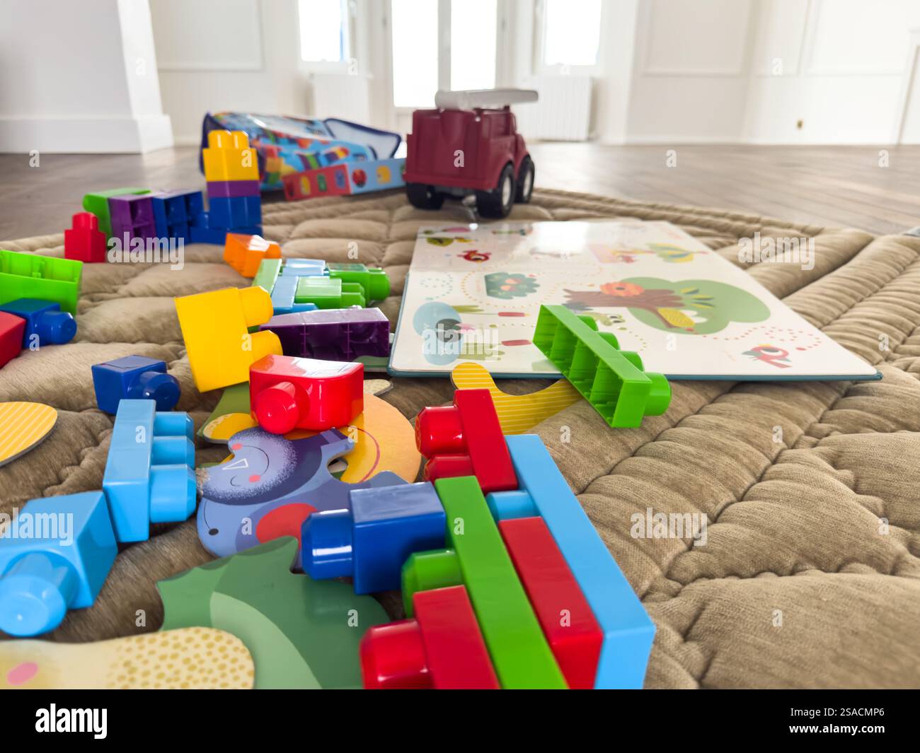 Colorful building blocks and toys scattered in a bright playroom for ...