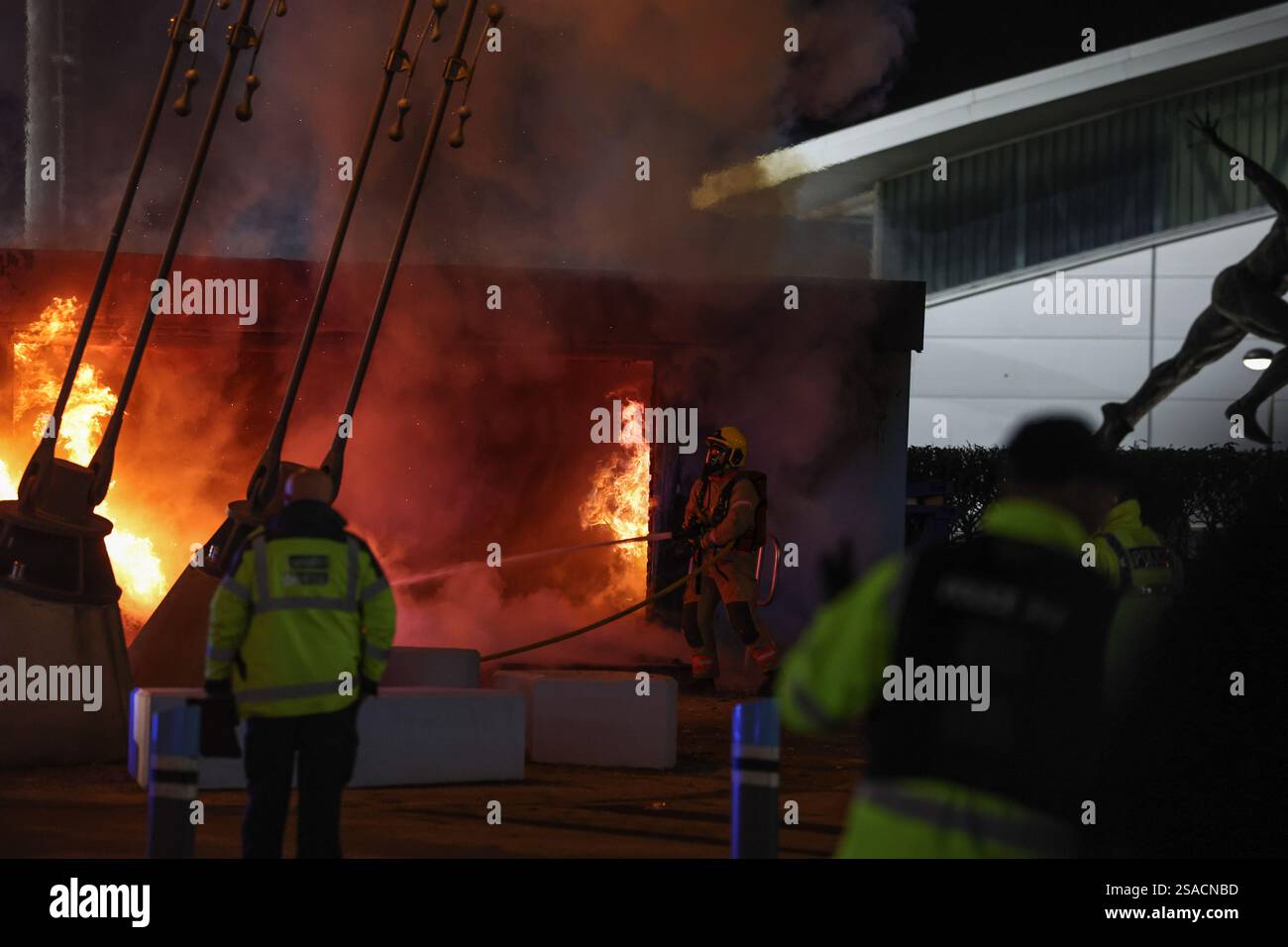 Fire fighters putting out a fire outside of the Etihad during the UEFA ...