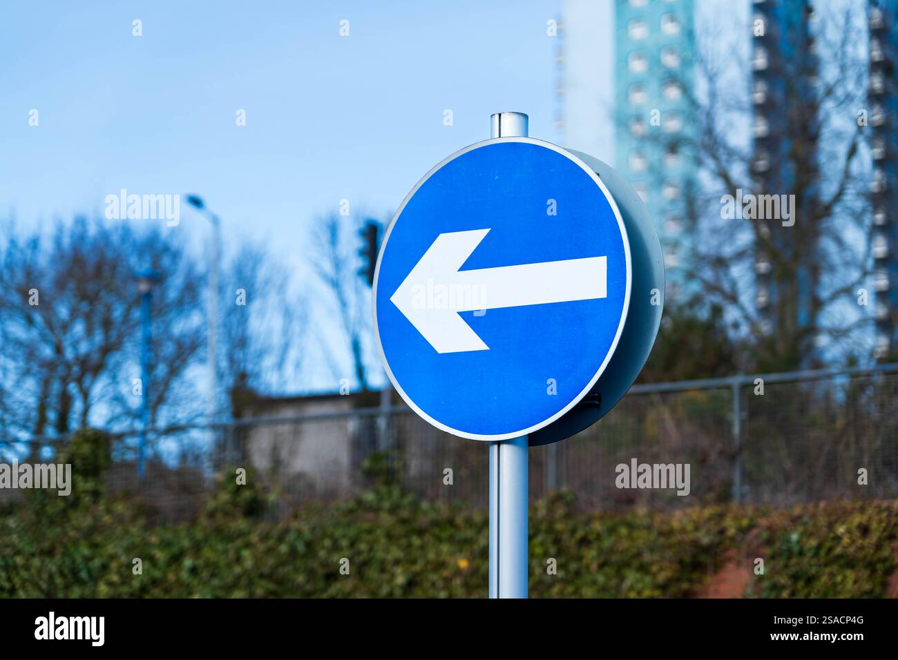 UK Traffic sign showing.a left turn onlywith a blue circle with a white ...