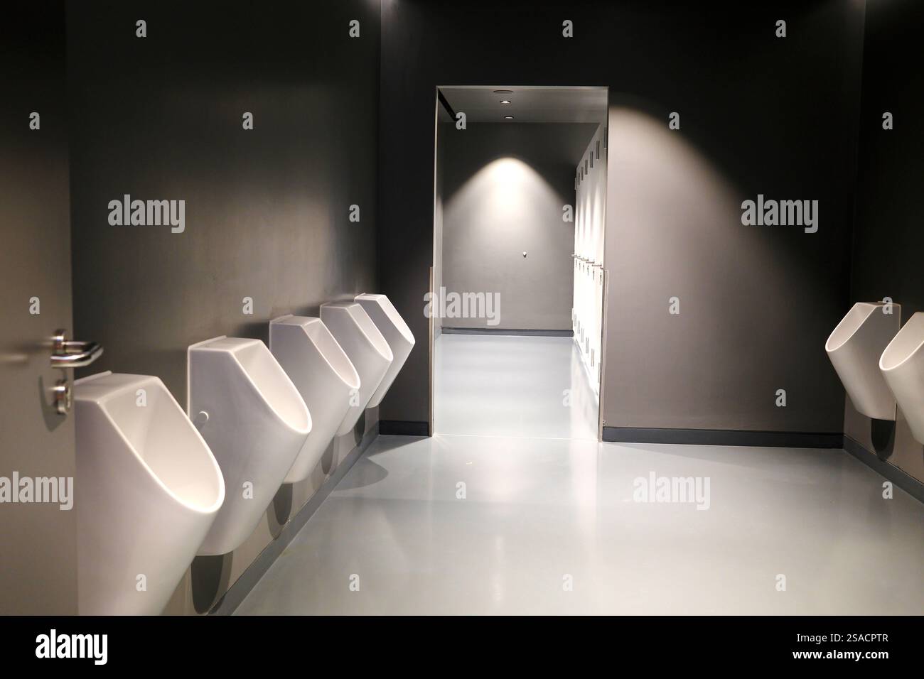 White urinals in men public toilet. Ceramic urinals in a row in men ...
