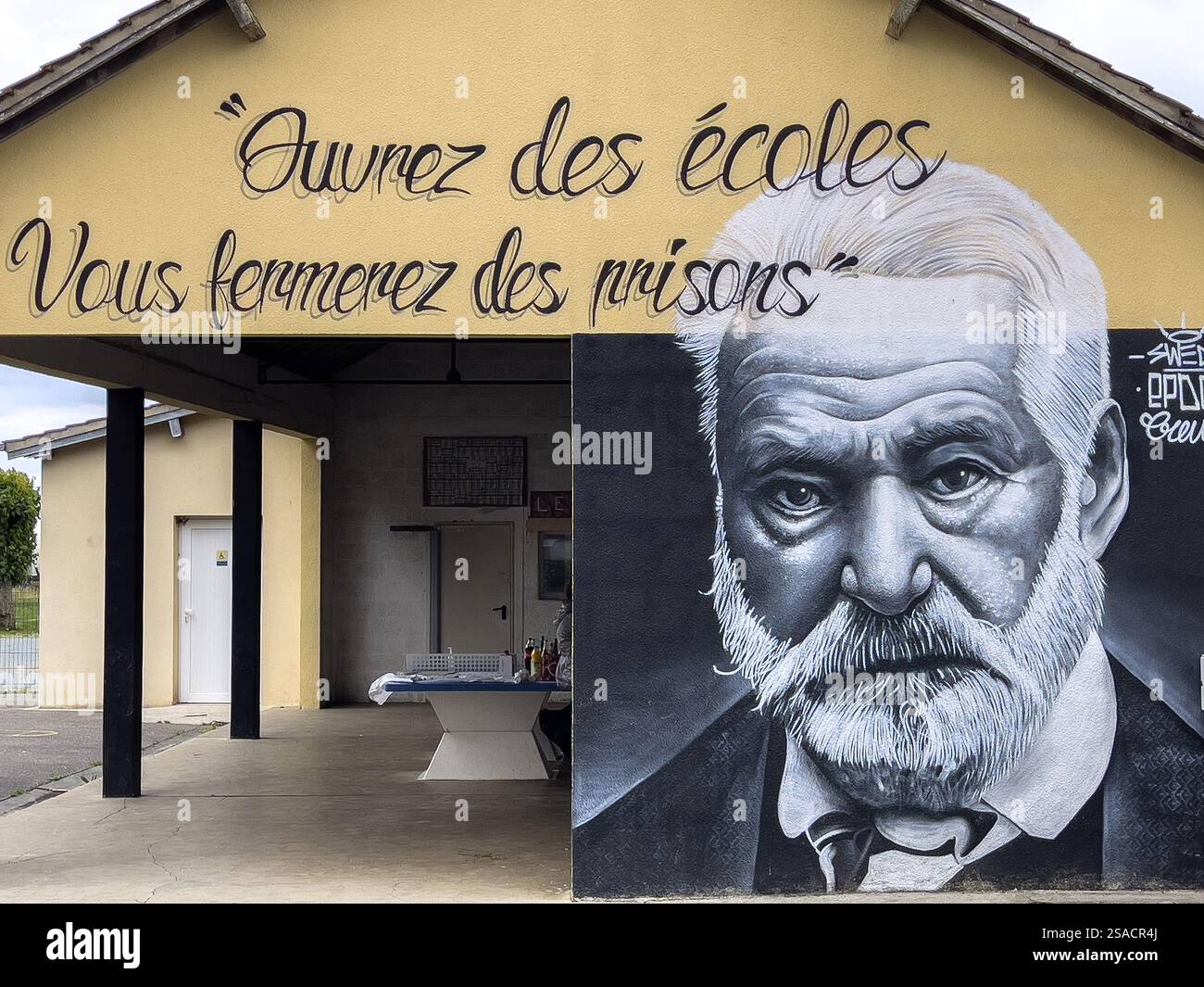 School with a portrait of Victor Hugo and quote : « Open schools, you ...
