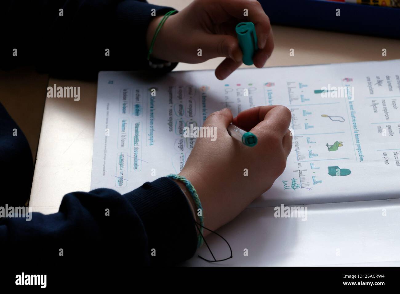 Primary school classroom with a pupil writing is work. France Stock ...