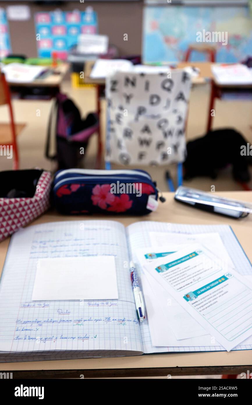 Primary school. Book and pencils on desk. c France Stock Photo - Alamy