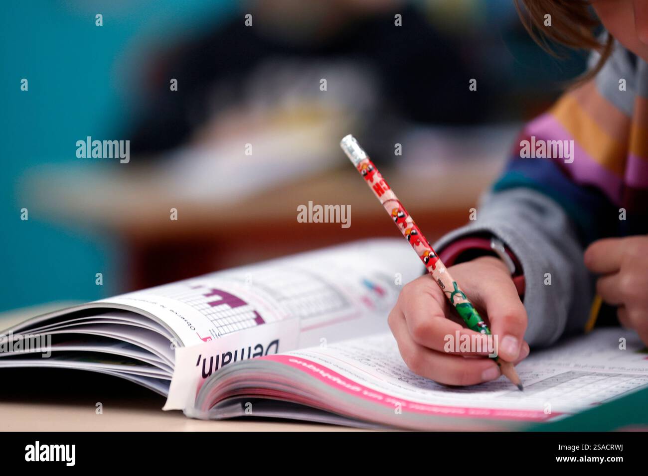 Primary school child writing on a desk during a lesson. France Stock ...