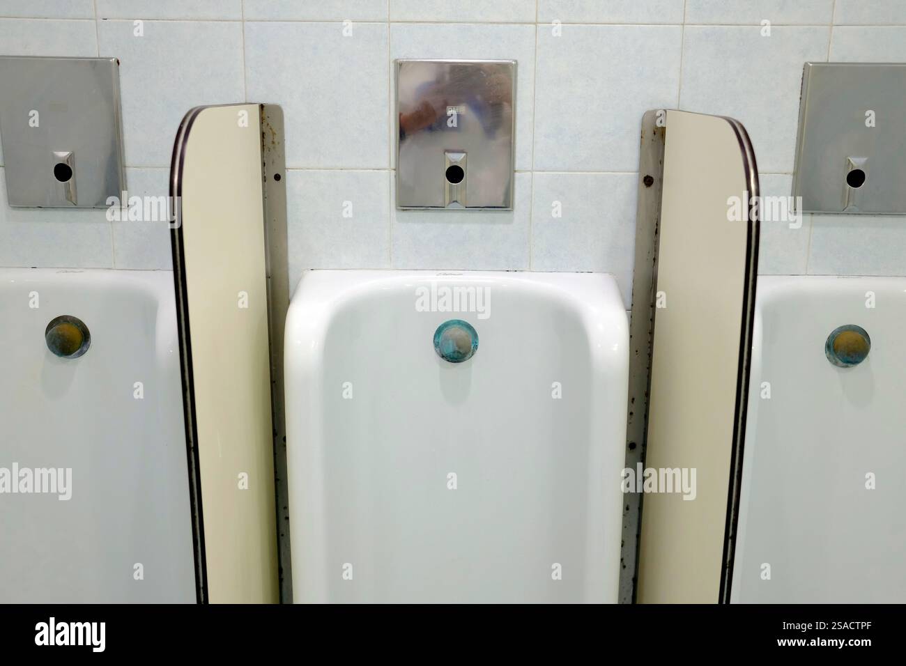 White urinals in men public toilet. Ceramic urinals in a row in men ...