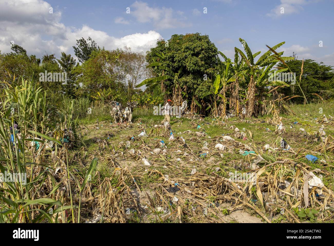 Farmer cleaning his field after the Athi river burst its banks and got ...