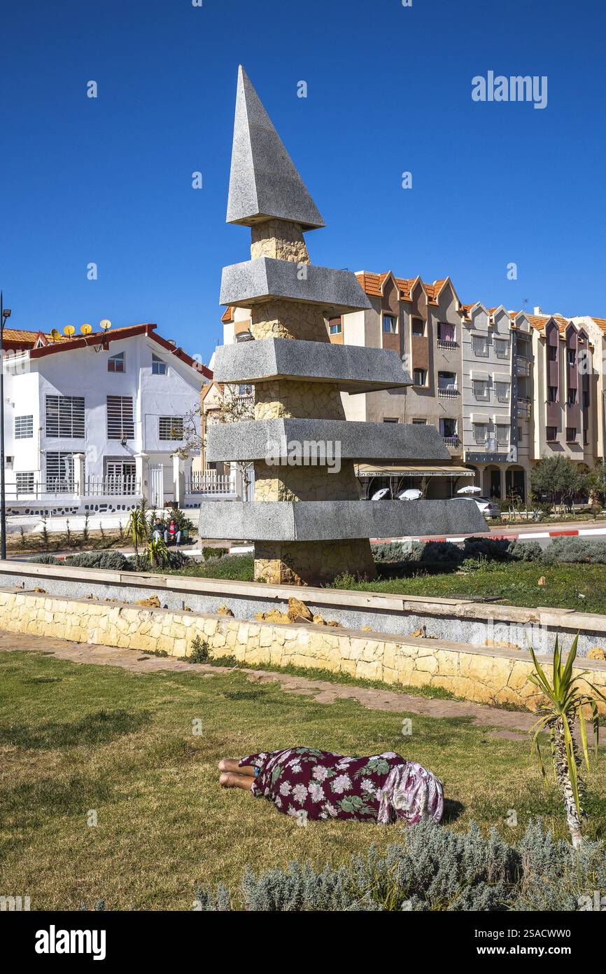 Woman sleeping on a lawn and monument in Azrou, Morocco Stock Photo - Alamy